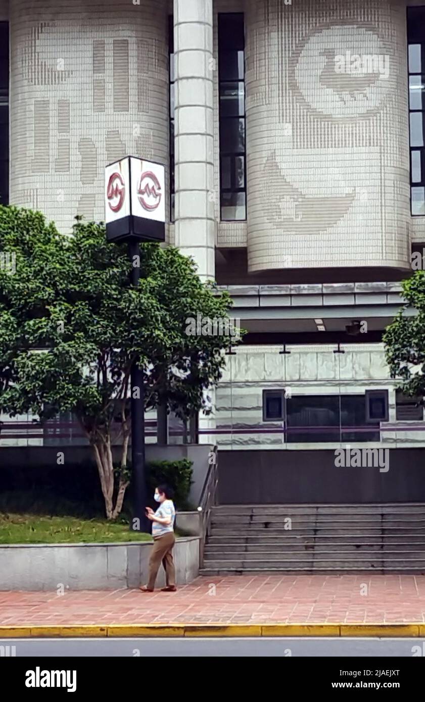 SHANGHAI, CHINA - MAY 29, 2022 - Citizens wear masks as they walk on a ...