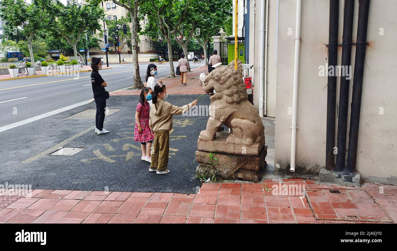 SHANGHAI, CHINA - MAY 29, 2022 - Citizens wear masks as they walk on a ...