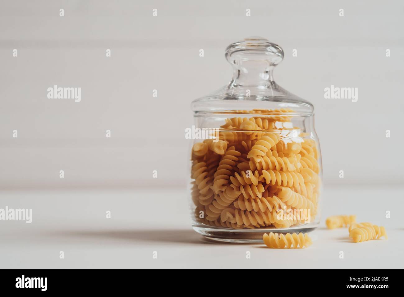 Pile of Wavy Pasta Stored in Glass on a White Background Stock Photo ...