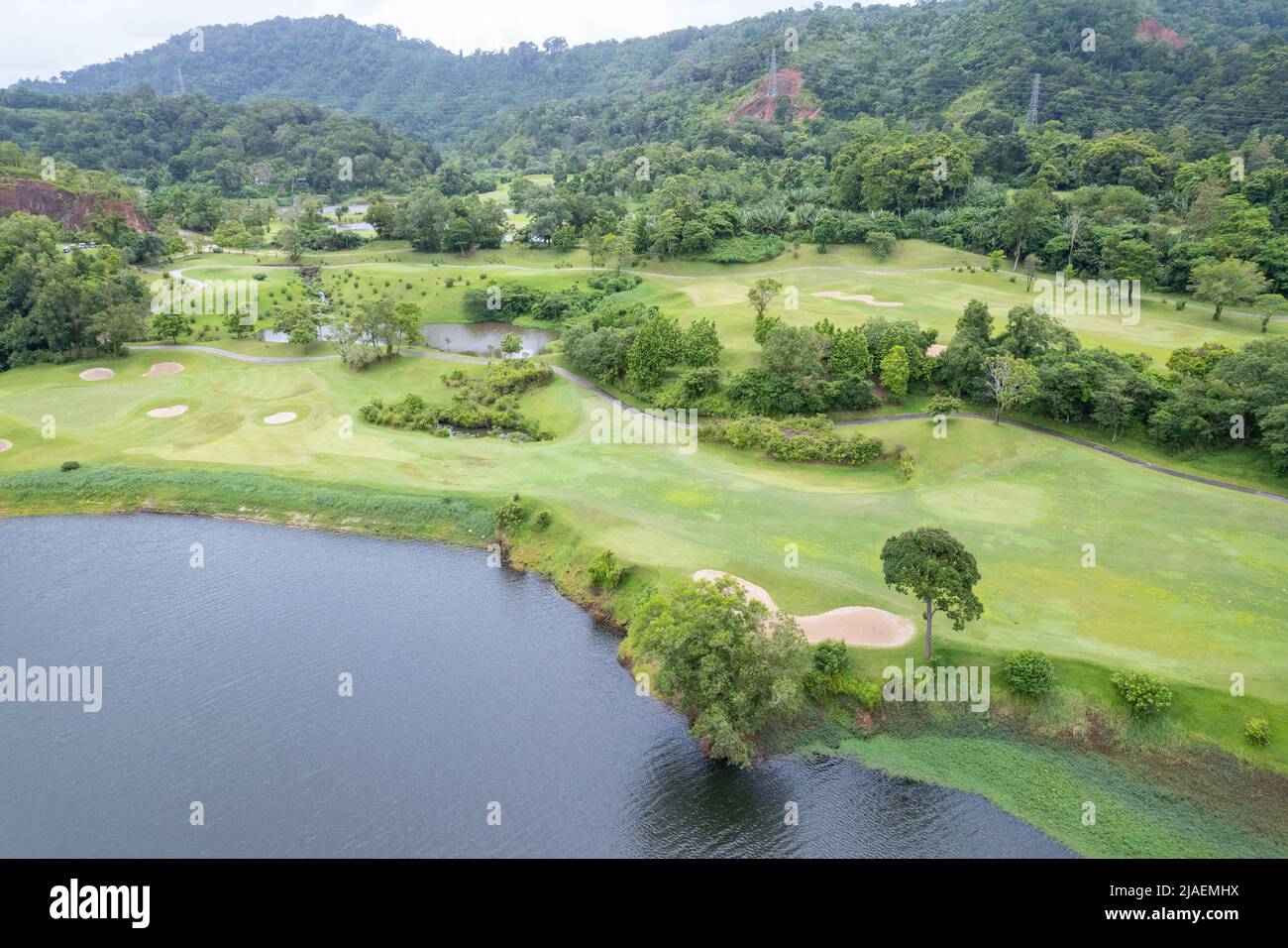 Aerial view drone shot of beautiful green golf field fairway and ...