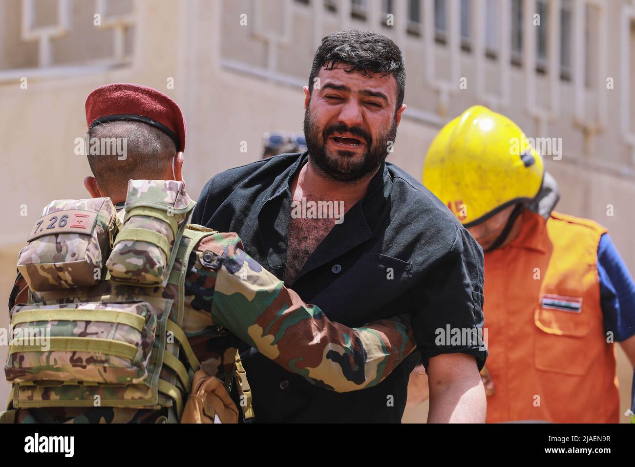 Baghdad, Iraq. 29th May, 2022. A man cries at the site where a fast ...