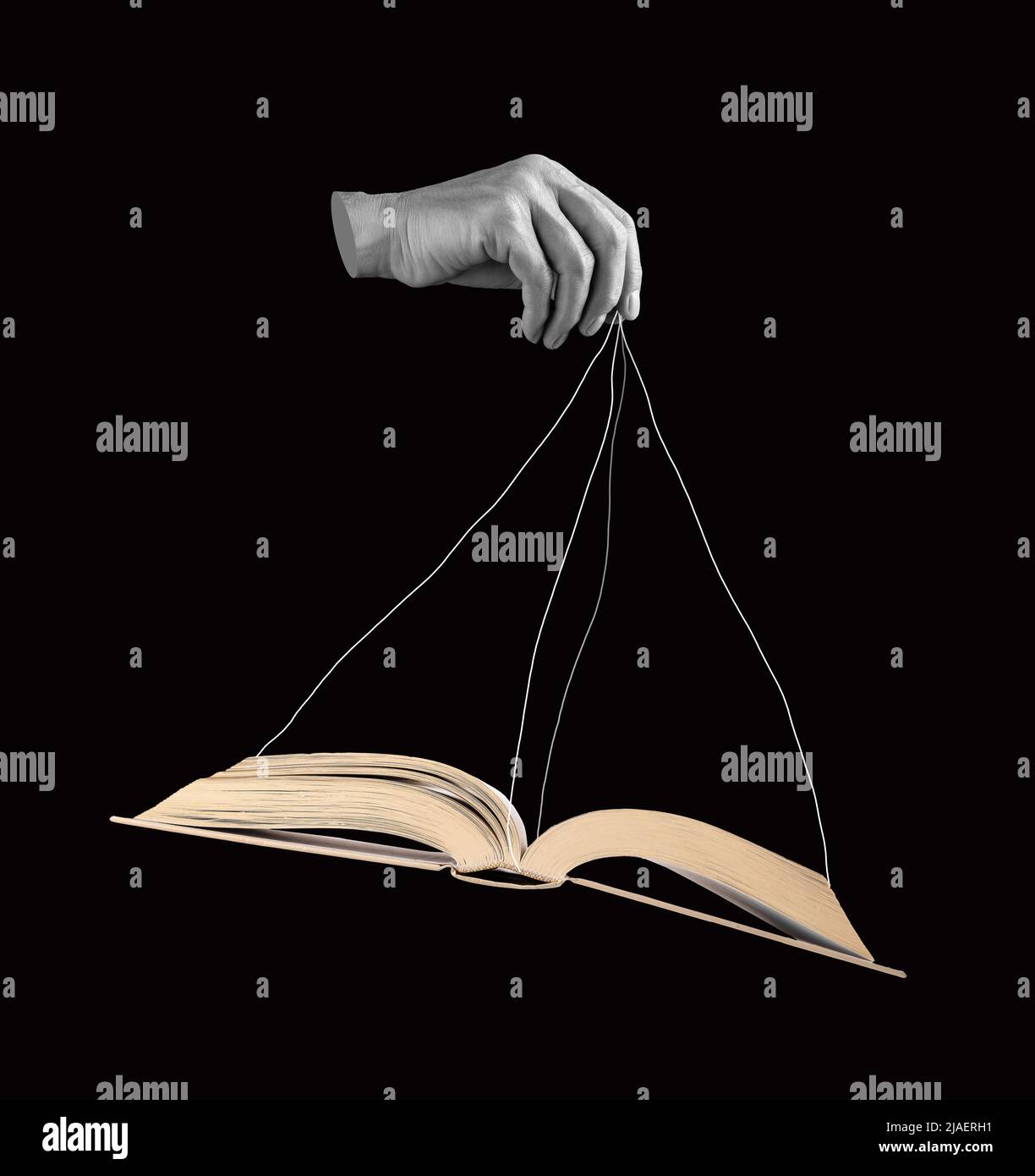 Hand holding book by strings. Using information, facts for manipulation ...