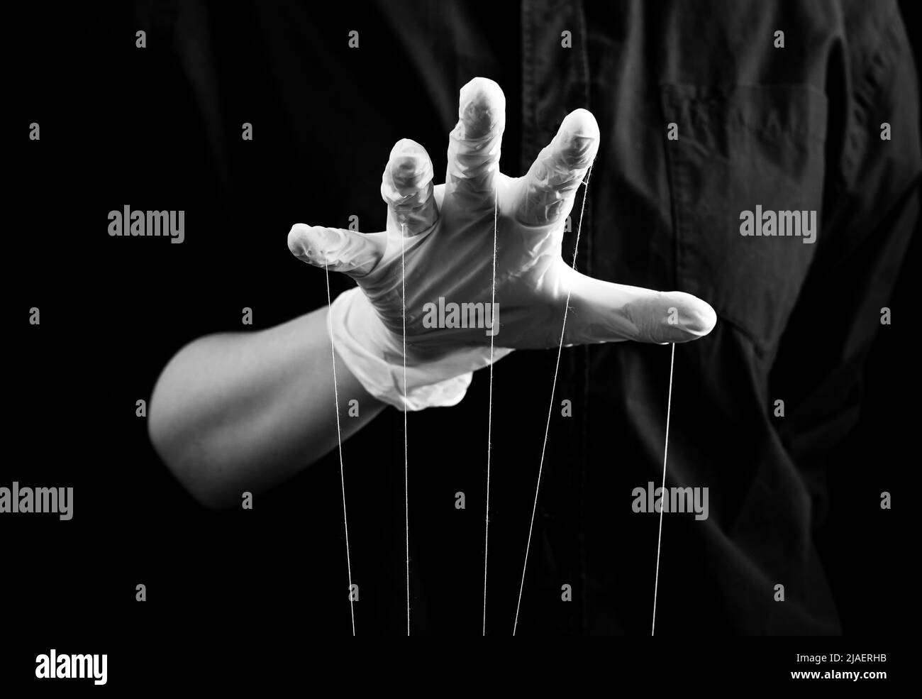 Hand in medical glove with strings on fingers. Deception in medicine ...