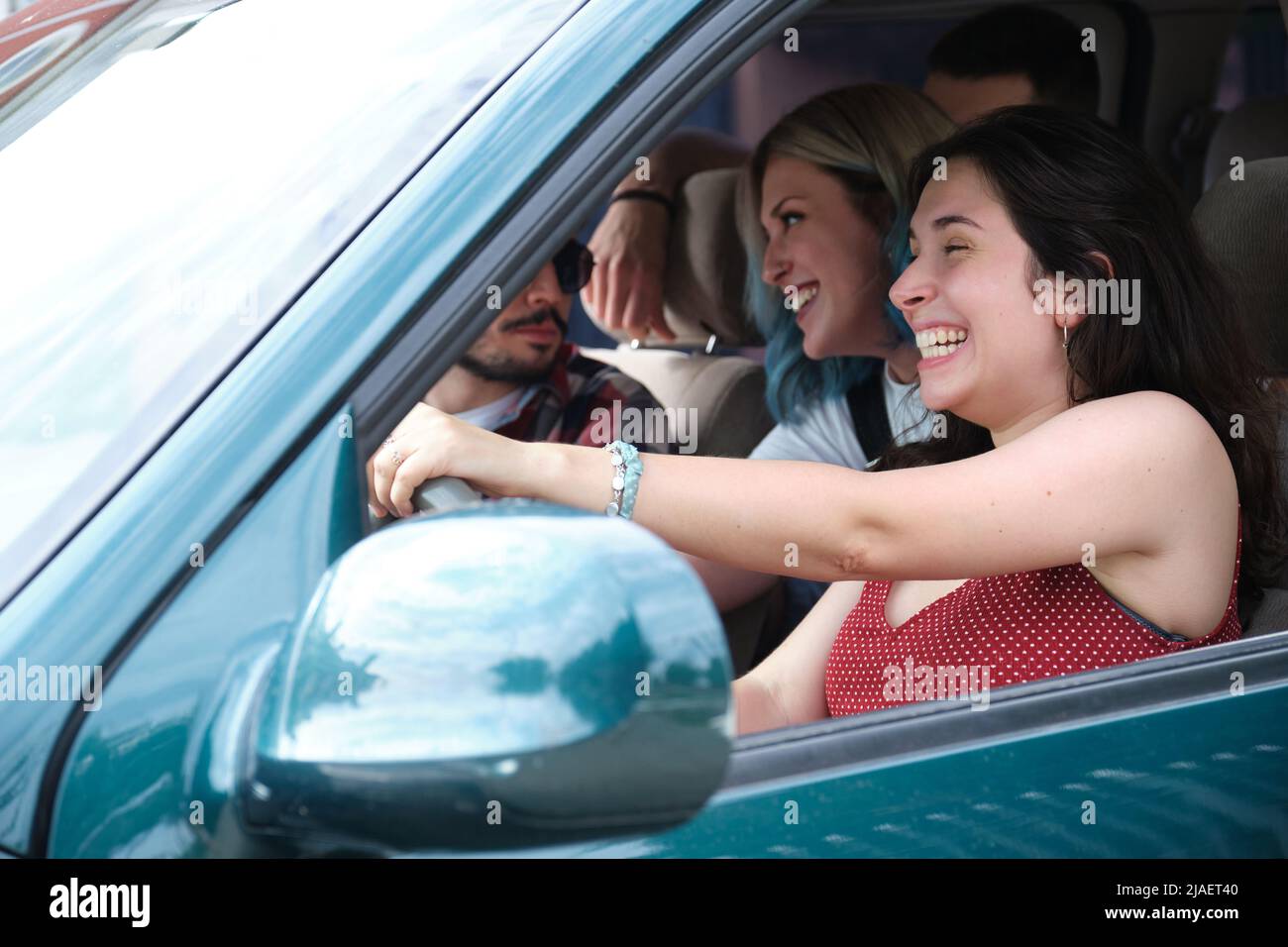 Group of friends travel together driving a car and making fun Stock ...