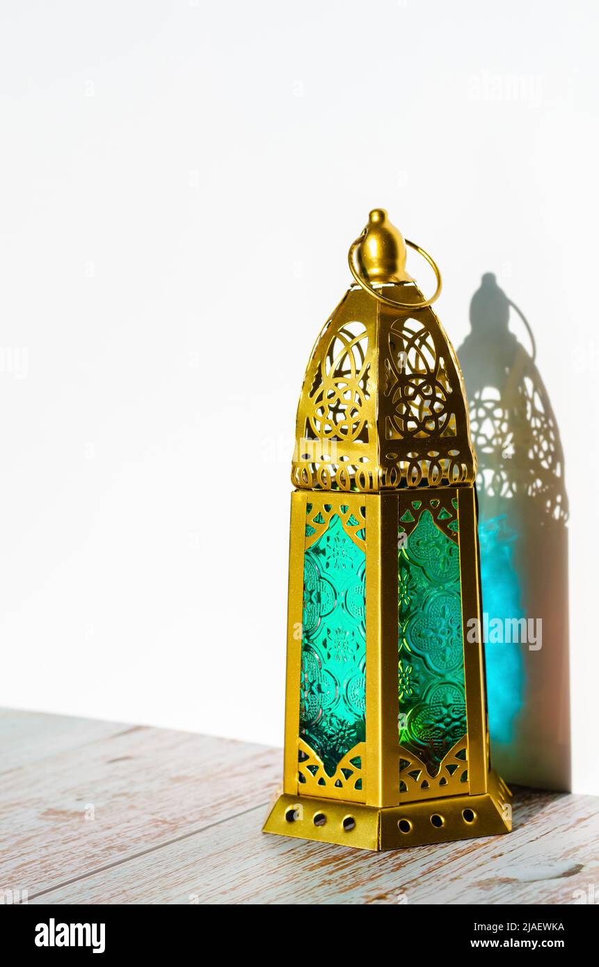 Golden lantern with shadow from sun light on white background Stock ...