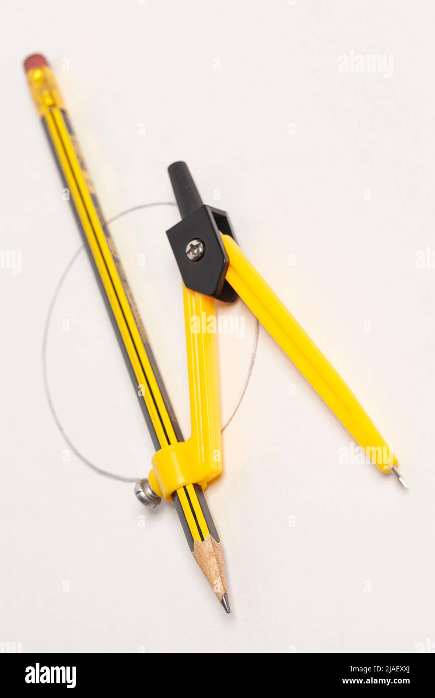 Yellow compass with pencil isolated on white background Stock Photo - Alamy