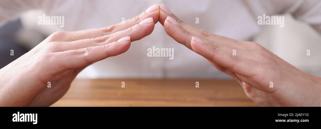 Female showing house roof with hands Stock Photo - Alamy