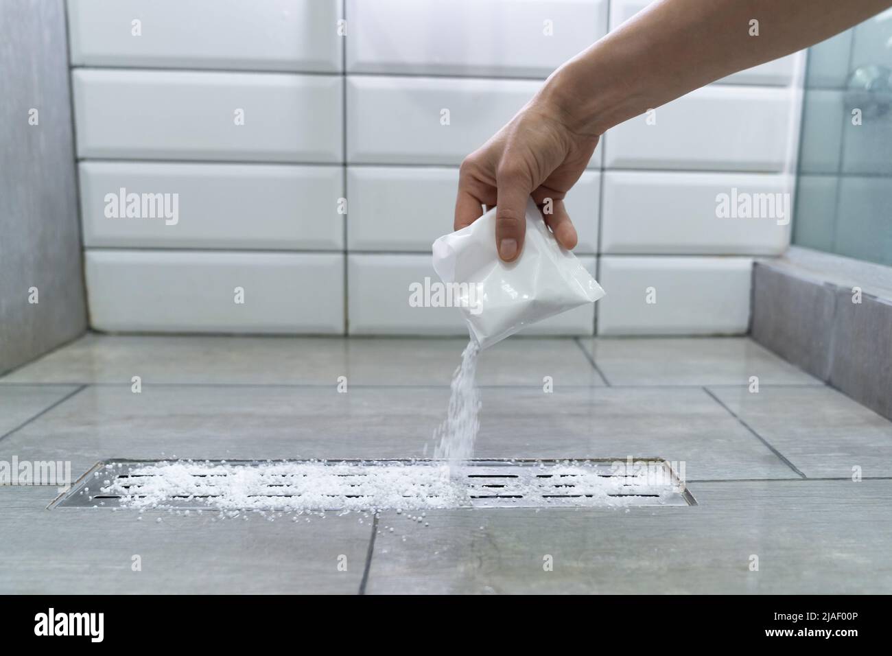Closeup of female hand pouring pipe cleaner granules. Clean the ...