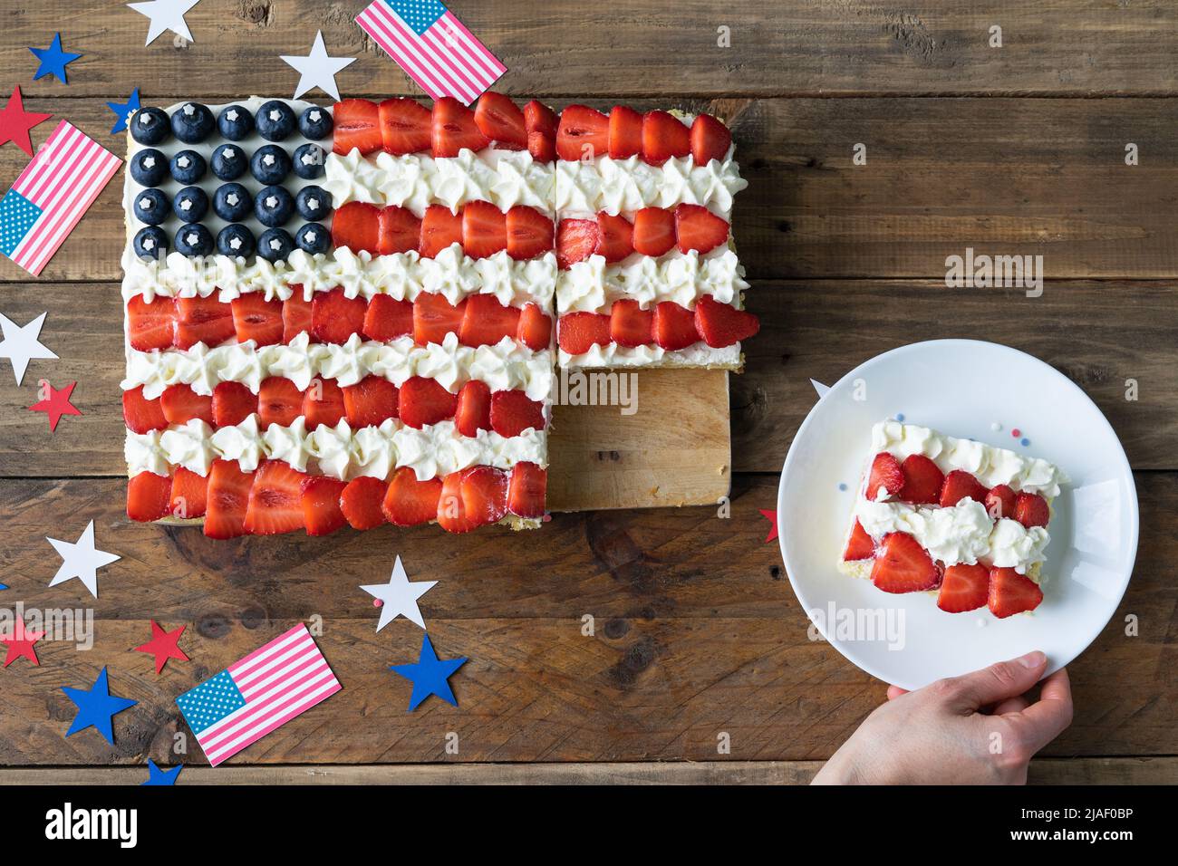 Square cake with the colors of the US flag on a wooden background with ...