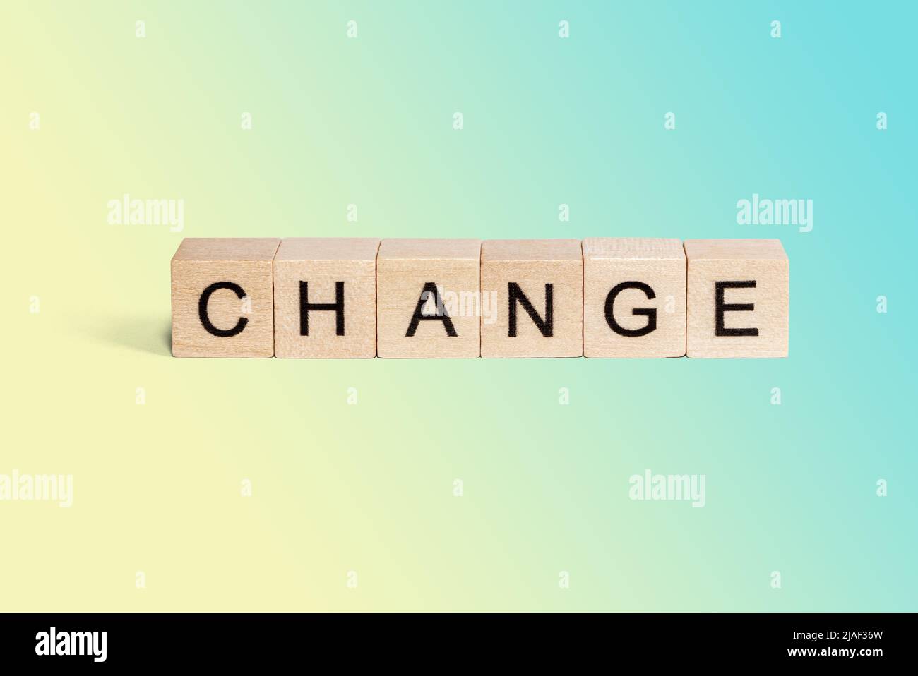 Wooden cubes with the word Change on a blue and yellow background with ...