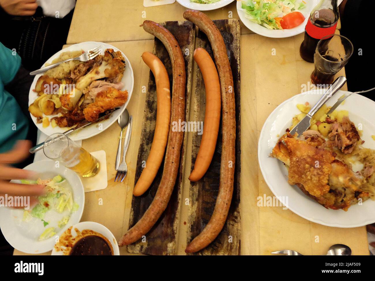 Close up German sausages and deep fried pork knuckle legs served with ...