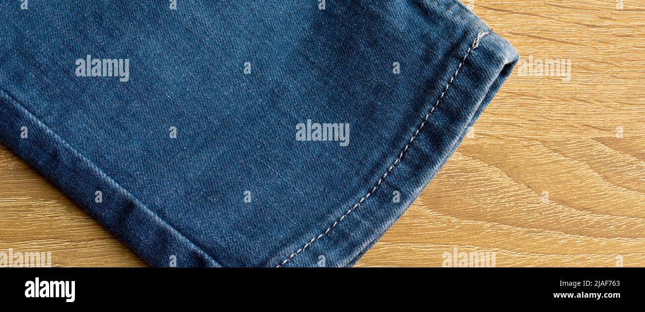 Seam blue denim cotton jeans leg detail, fabric texture background and ...