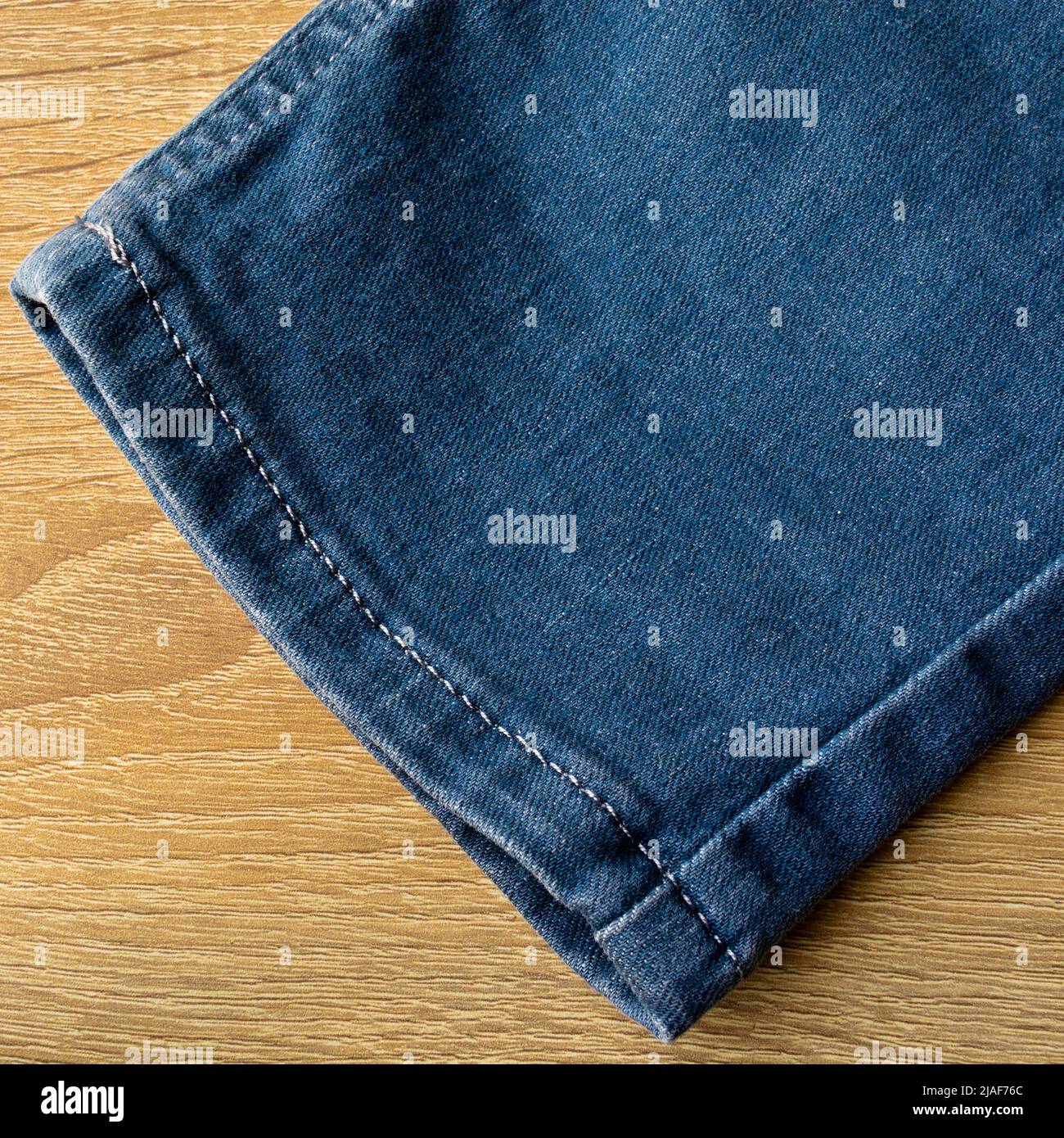 Seam blue denim cotton jeans leg detail, fabric texture background and ...