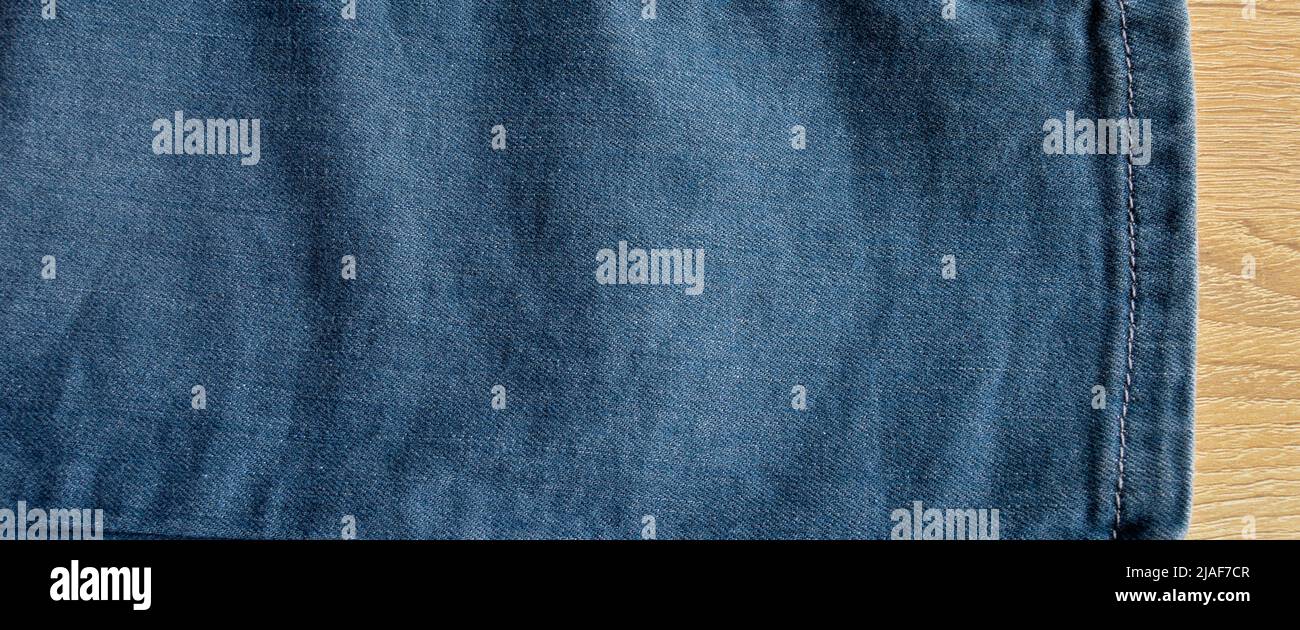 Seam blue denim cotton jeans leg detail, fabric texture background and ...
