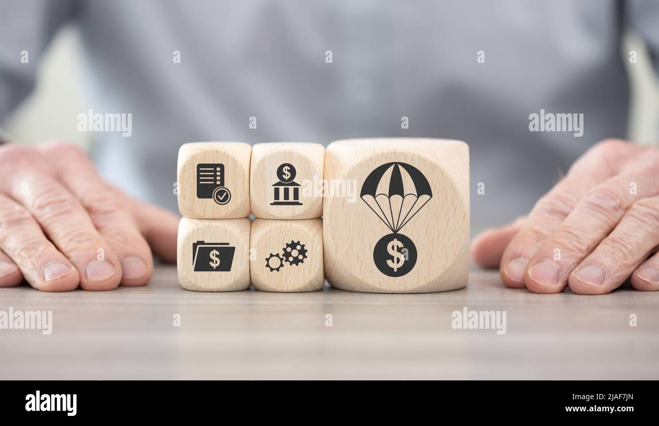 Wooden blocks with symbol of government aid concept Stock Photo - Alamy
