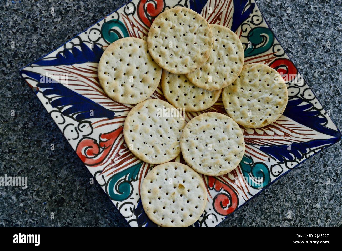 Cracker biscuits on a colorful dish Stock Photo - Alamy