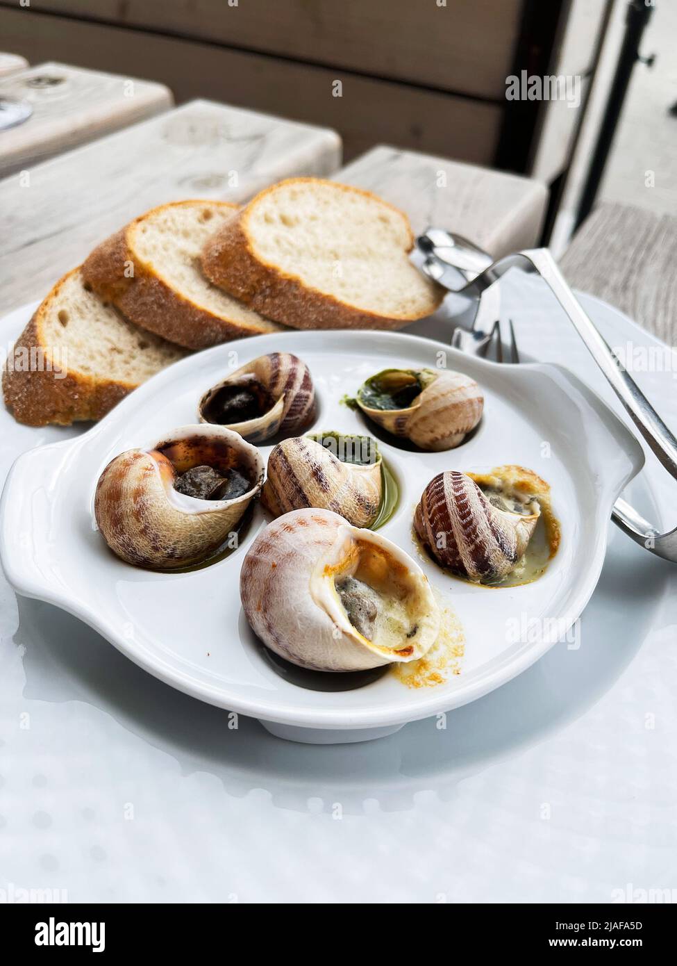 Closeup of eating the fried snails with garlic butter Stock Photo - Alamy