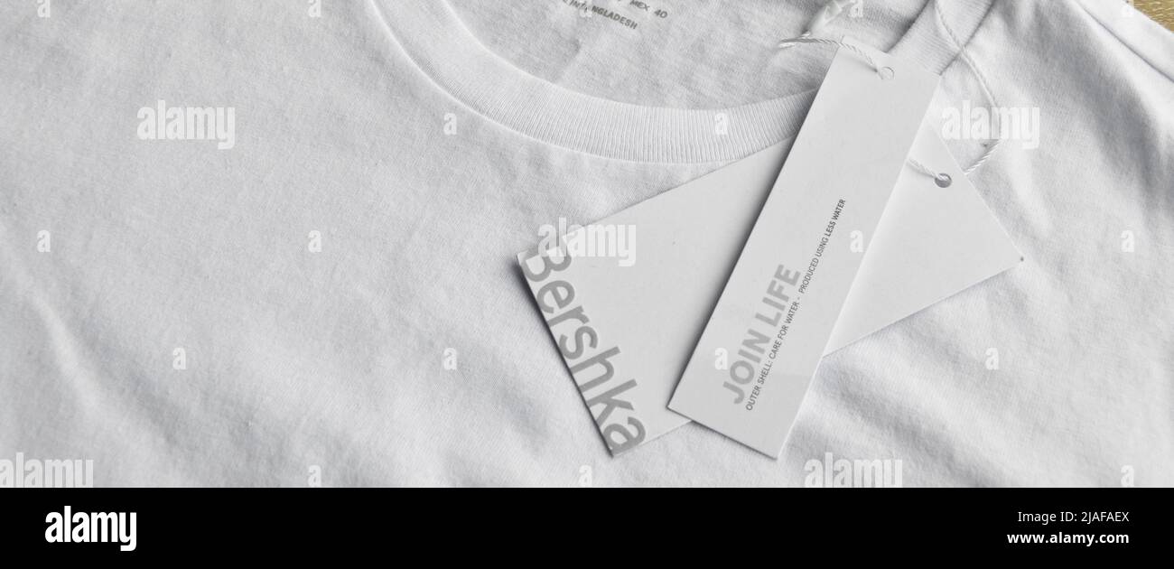 New white Bershka L t-shirt and blank label, on wooden floor, may 01 ...