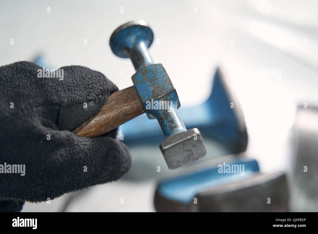 Worker hand holding hammer with metal head Stock Photo - Alamy