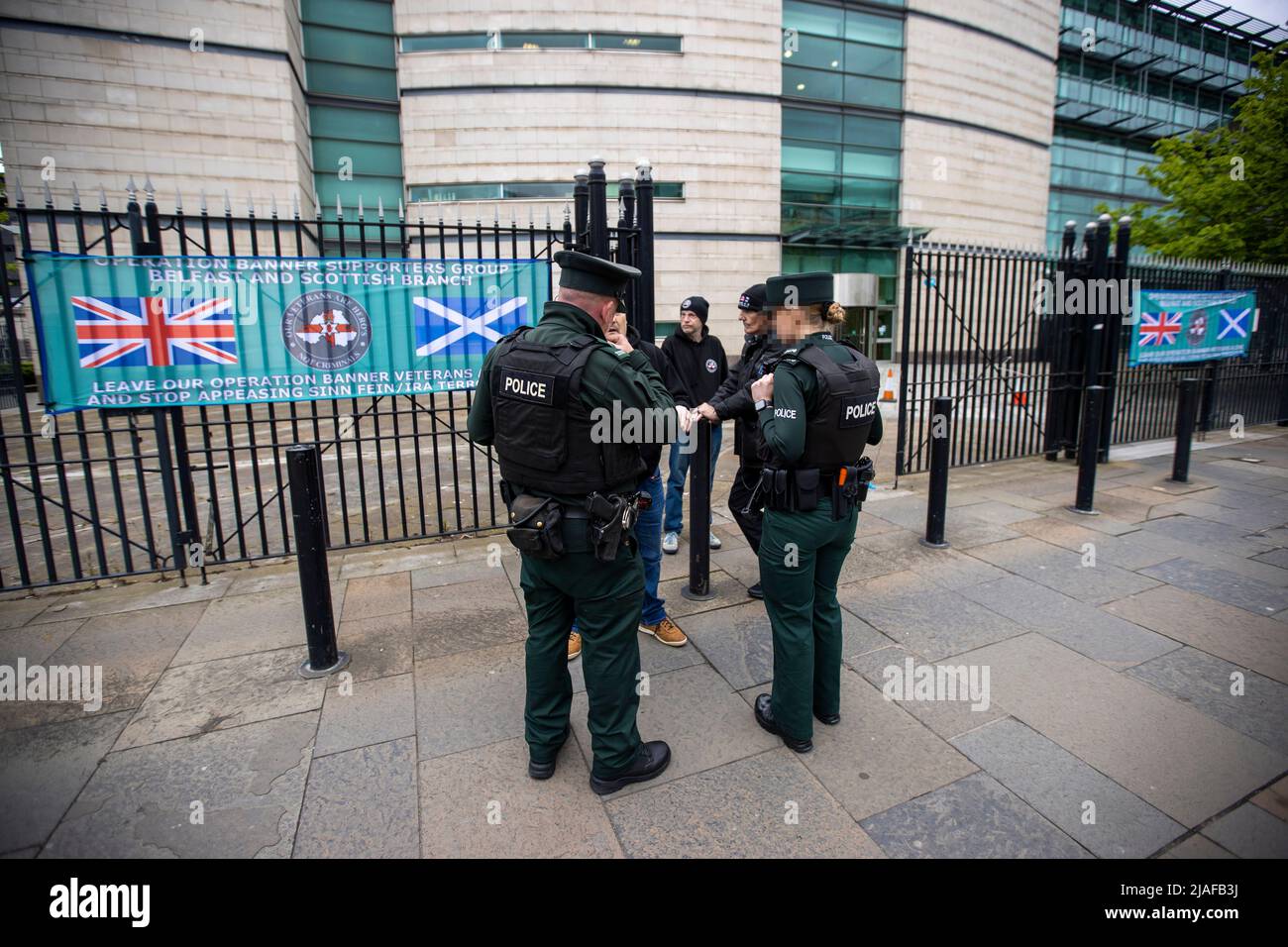 NOTE: IMAGE PIXELATED AT THE REQUEST OF THE PSNI PSNI officers speaking ...