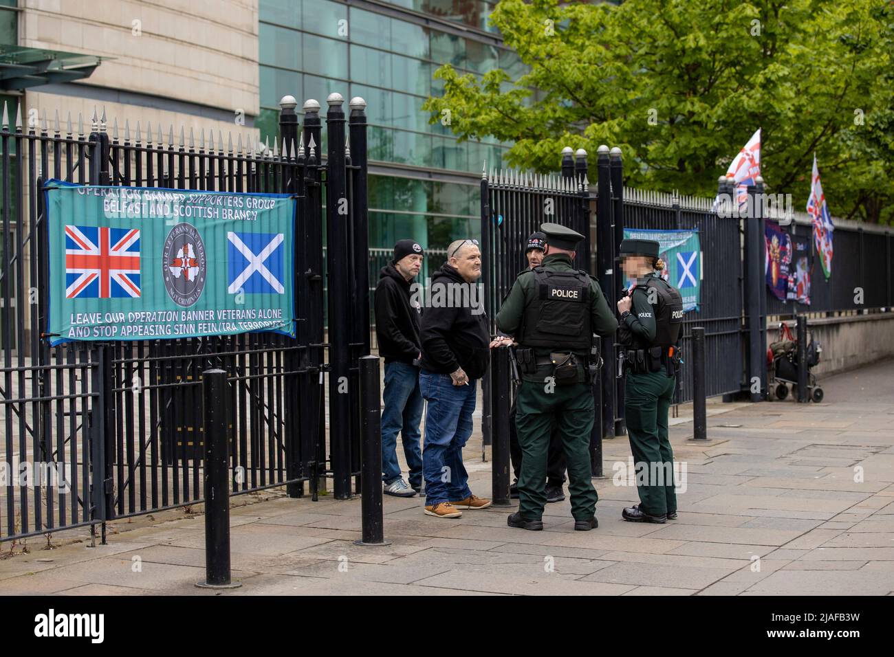 NOTE: IMAGE PIXELATED AT THE REQUEST OF THE PSNI PSNI officers speaking ...