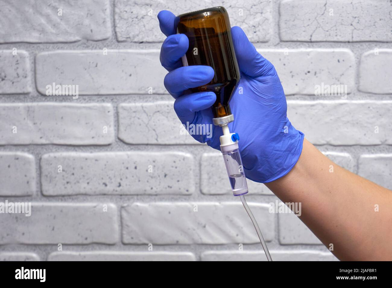 Medical dropper and doctor's hand in a glove against the background of ...