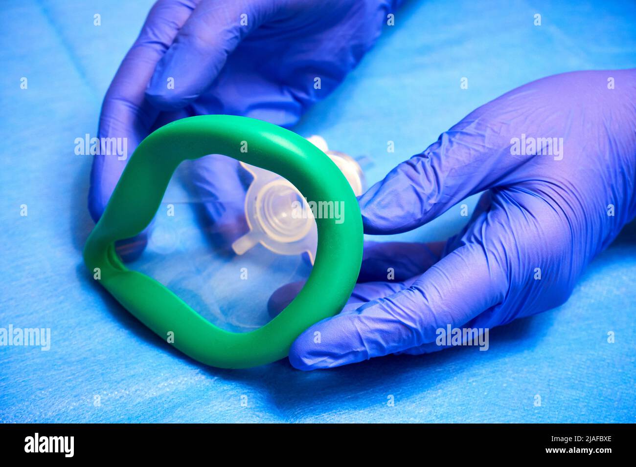 Mask for anesthesia and hands of a medic Stock Photo - Alamy
