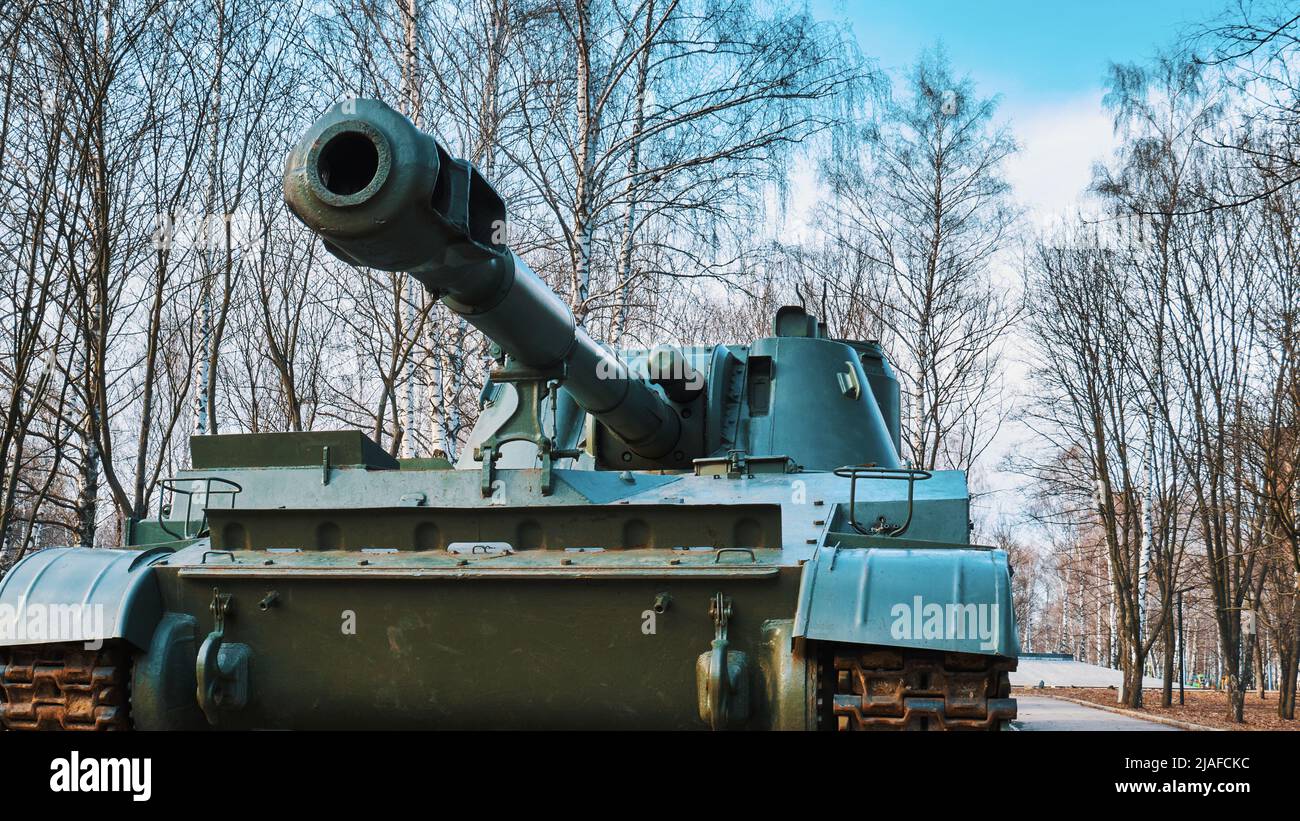 The barrel of a cannon of a Russian self-propelled howitzer against the ...