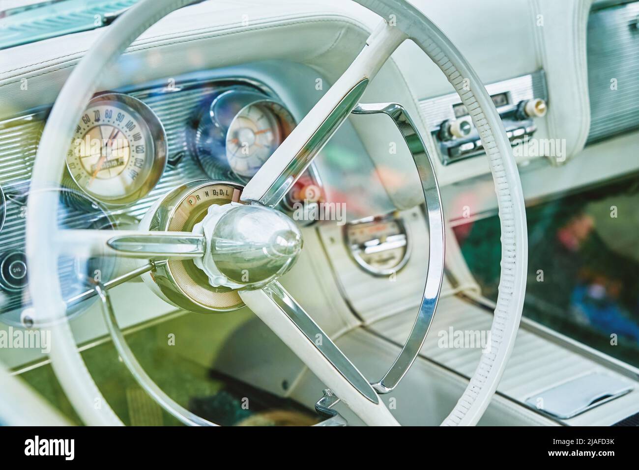 Retro car bright interior, dashboard and steering wheel with controls ...