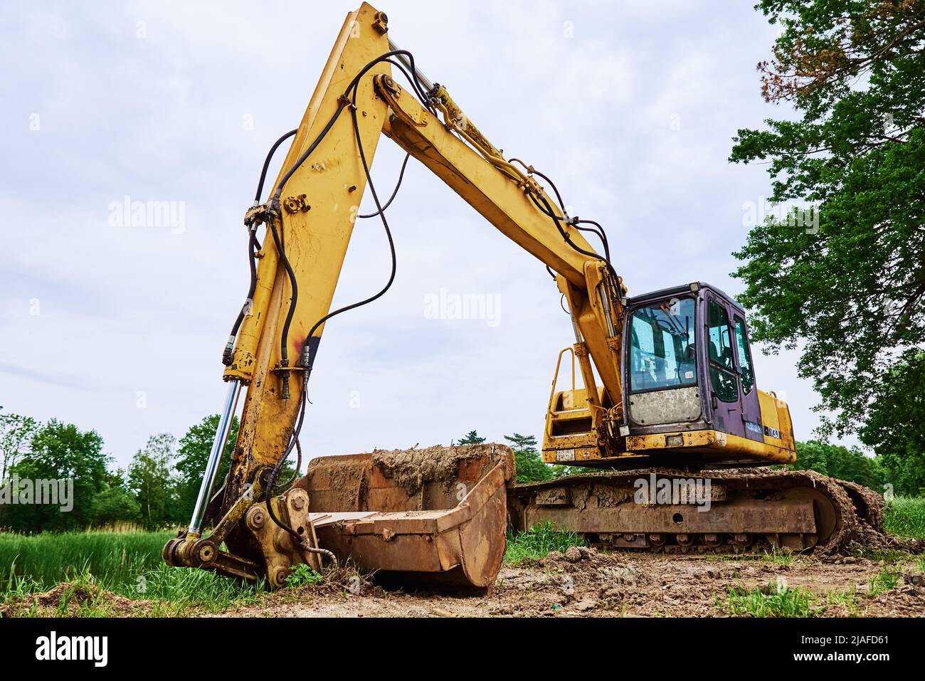 Yellow excavator on construction site, Heavy construction machine ...