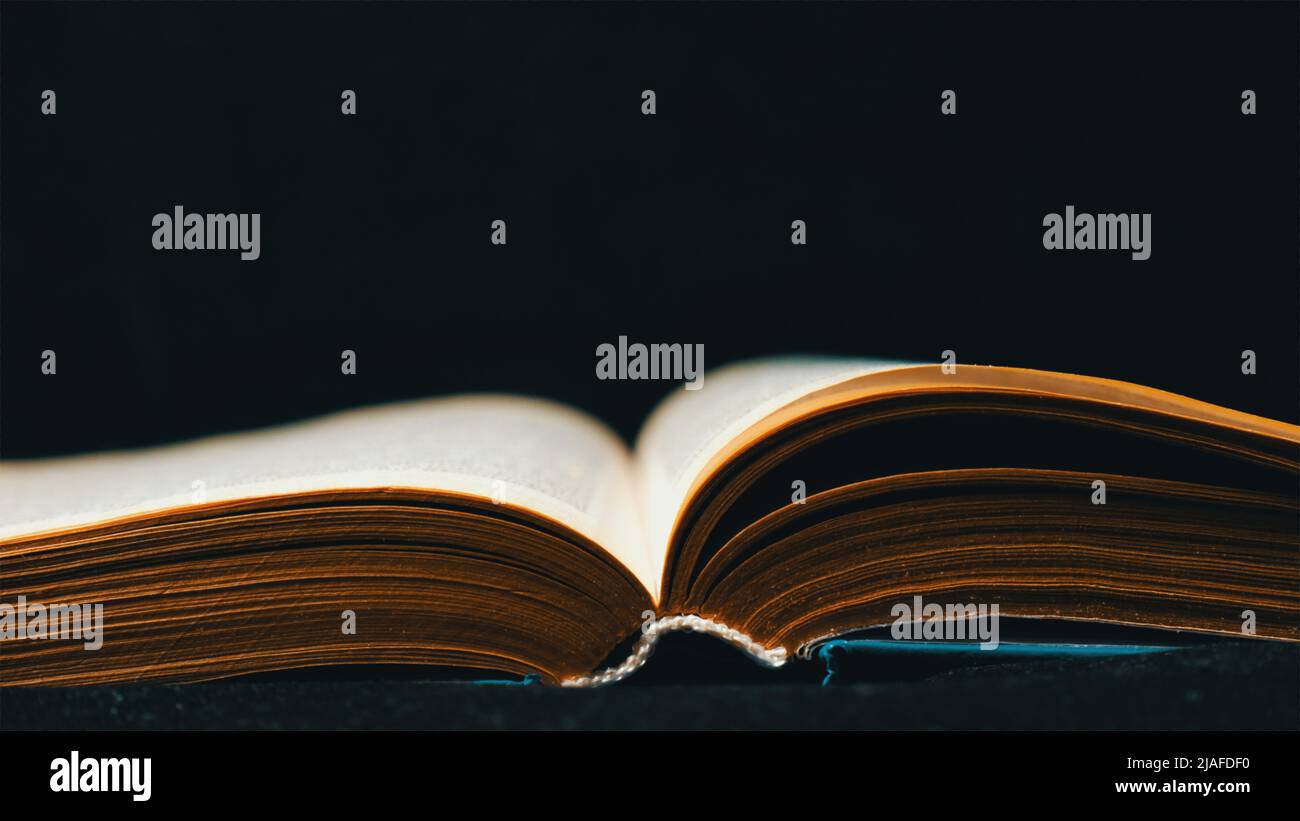 open old book on dark background Stock Photo - Alamy