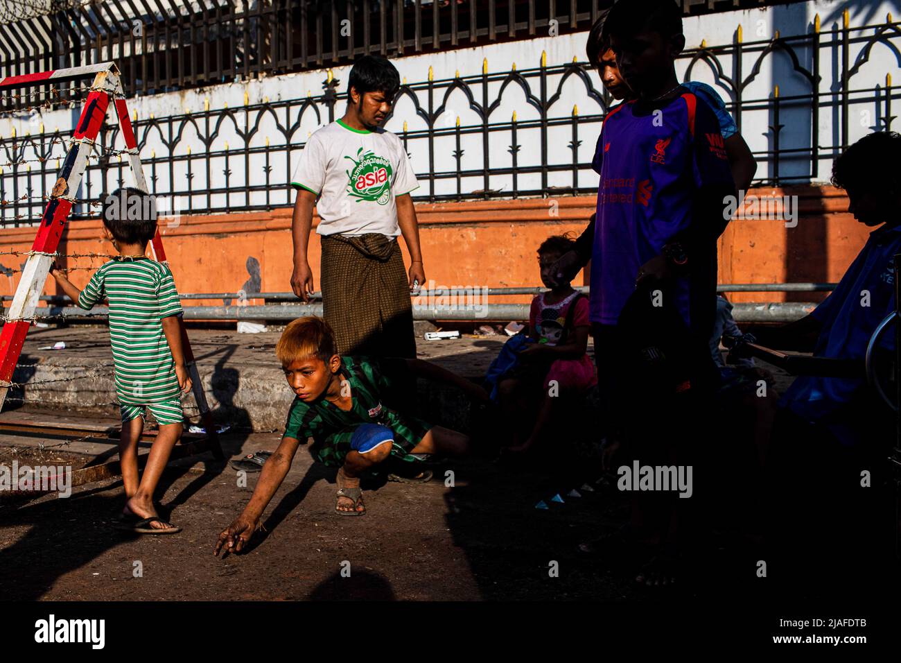 Children playing marbles on street hi-res stock photography and images ...