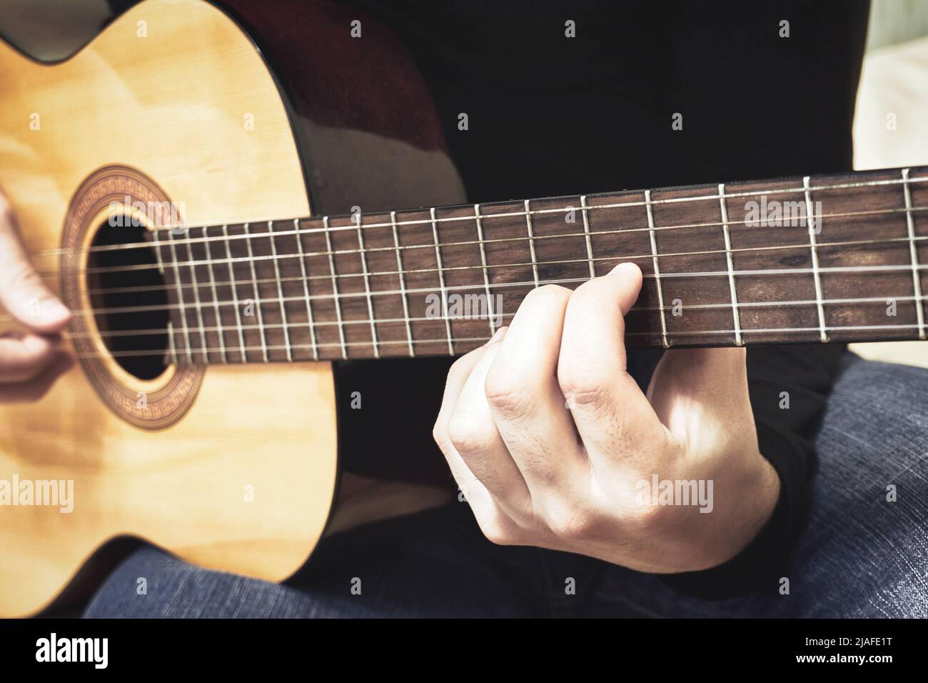 Close-up of a male hand on the fretboard of a classical guitar Stock ...