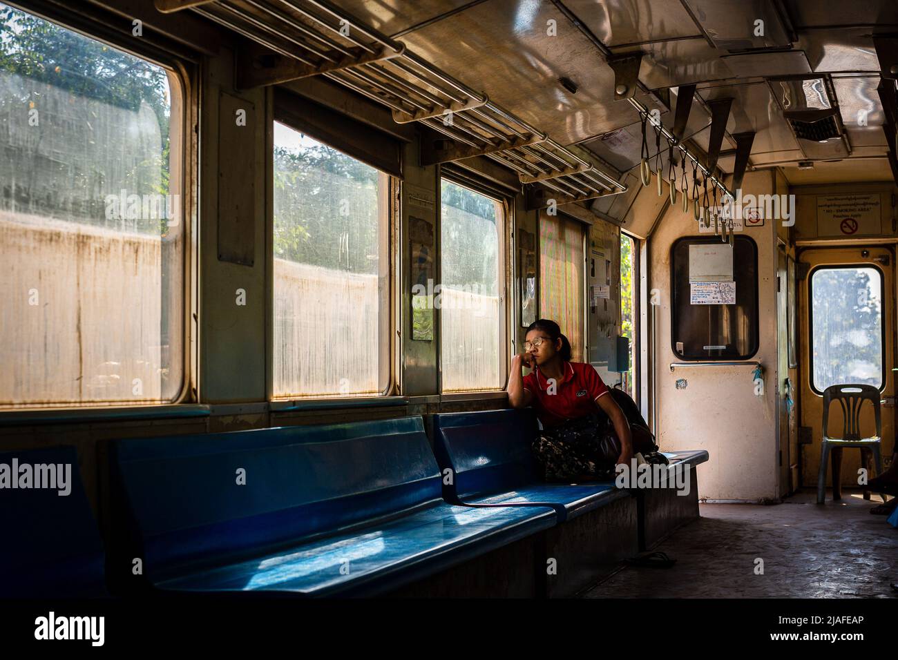 Yangon, Myanmar. 13th Jan, 2020. A woman sits on an empty carriage ...