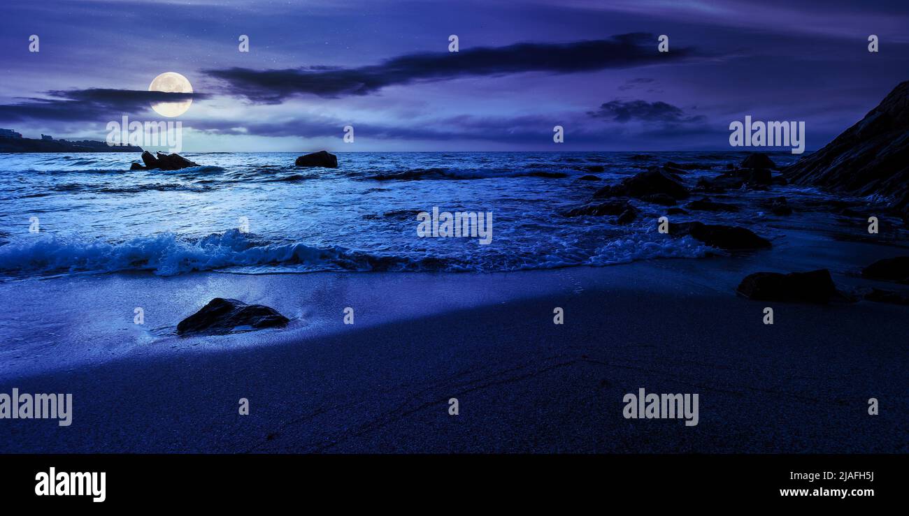sandy beach at night. beautiful seascape background. calm waves washing ...
