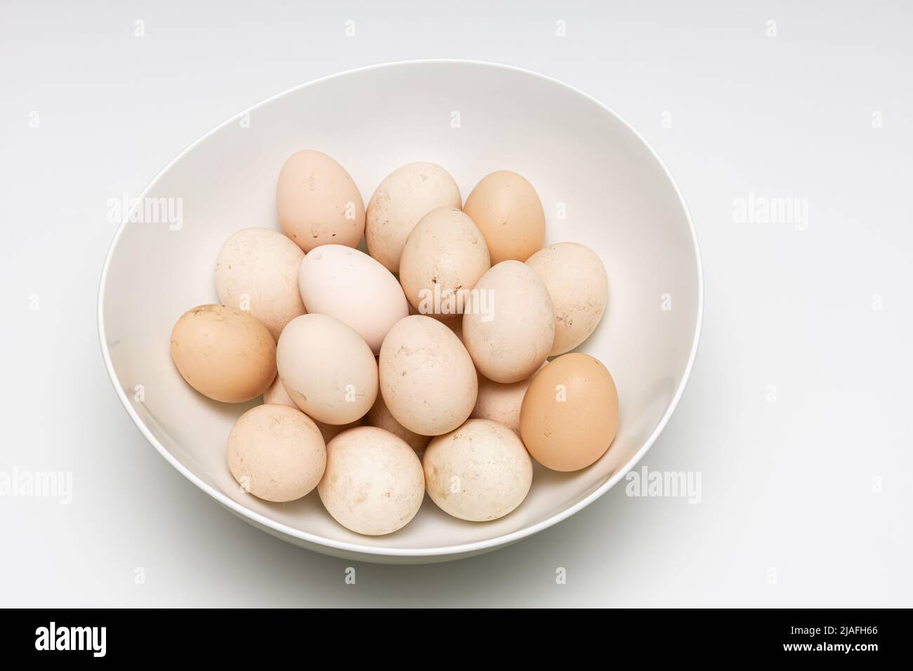 fresh unwashed rustic eggs lie in a deep bowl. High quality photo Stock ...