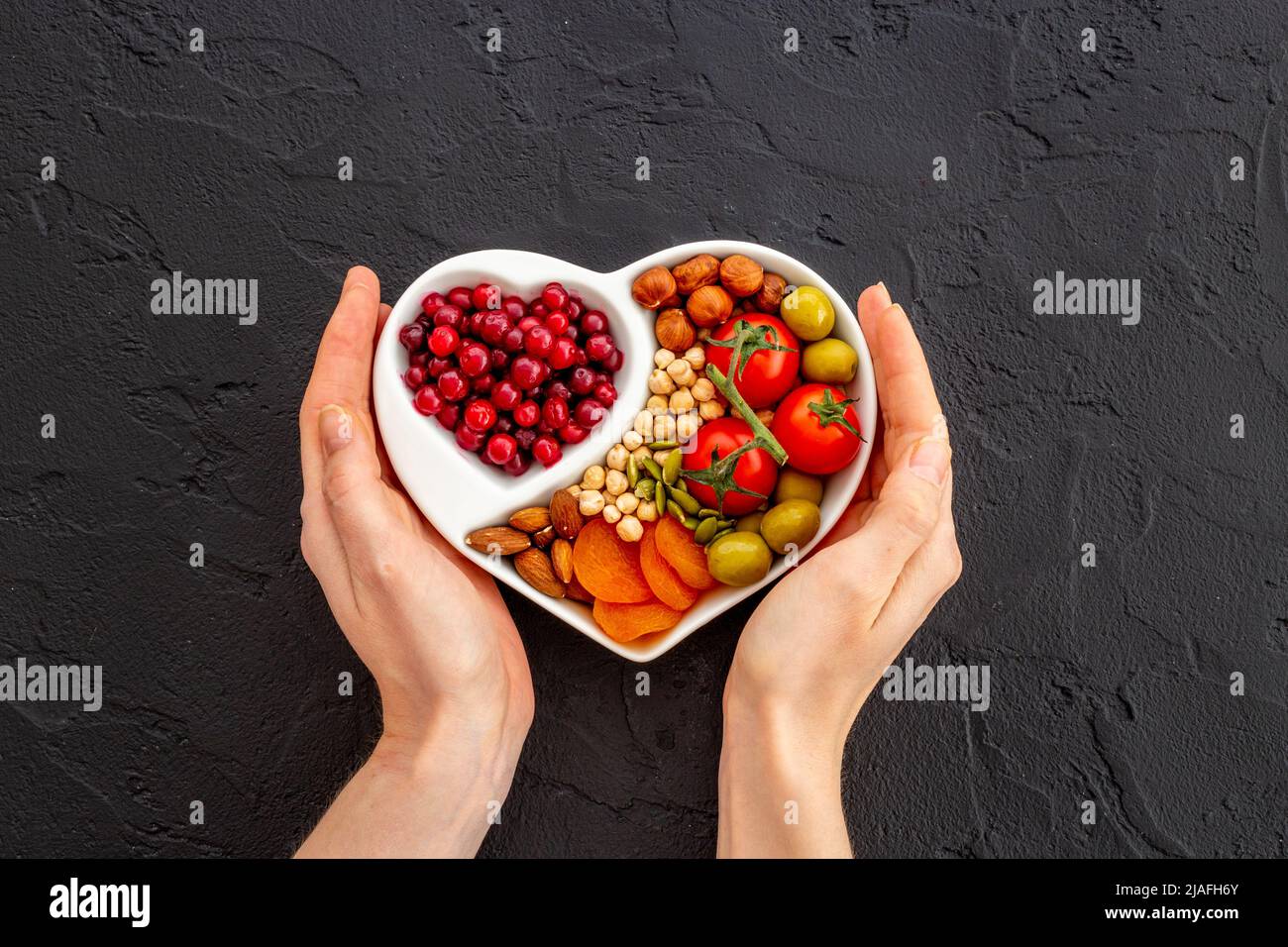 Hands with heart shaped dish of healthy diet food Stock Photo - Alamy