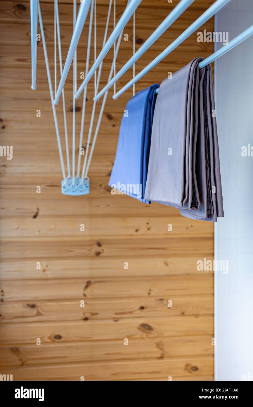 clothes dryer attached to the ceiling with clothes hanging. High ...