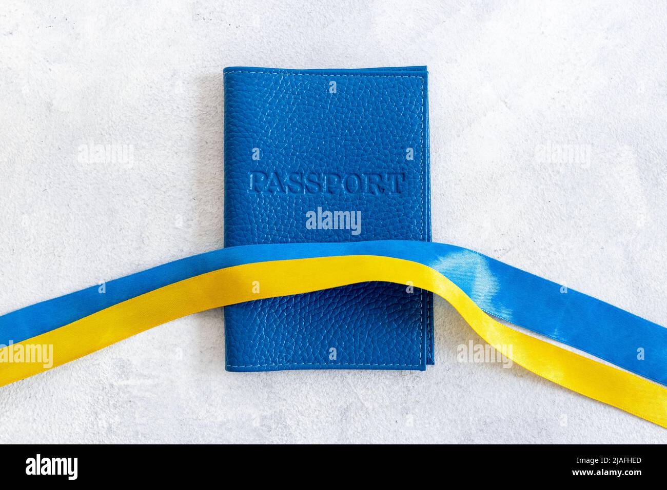 Yellow and blue ribbon with passport. Ukrainian immigration concept ...