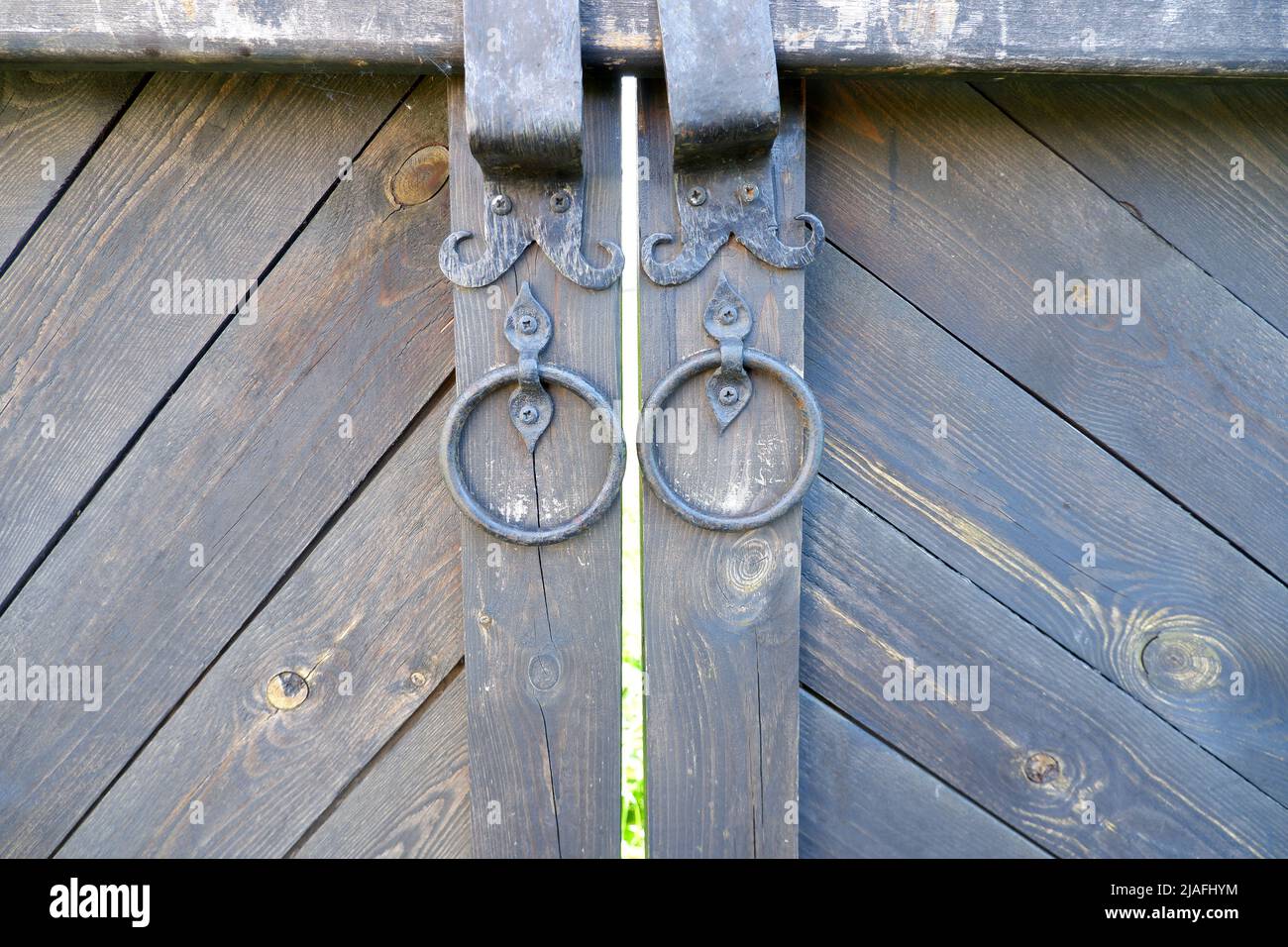 Closed vintage wooden gate with metal handles Stock Photo - Alamy