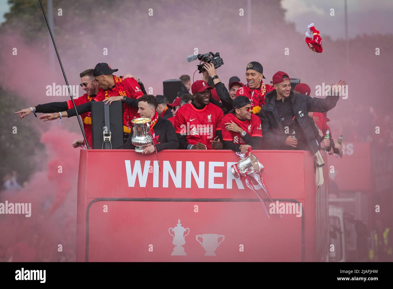 The Liverpool FC squad celebrate during the open top bus parade through ...