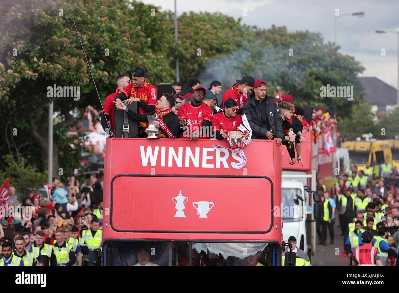 The Liverpool FC squad celebrate during the open top bus parade through ...