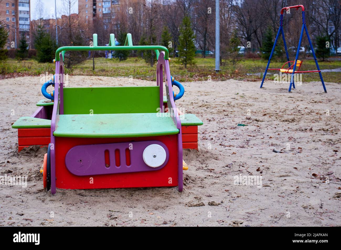 Children's sandbox in the form of a car. Playground in an autumn park ...
