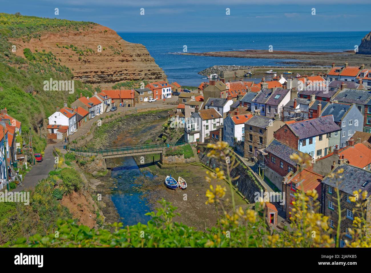 Staithes village with Staithes Beck flowing towards the harbour and the ...