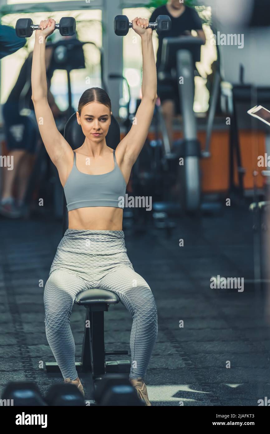 Vertical indoor full body shot of a strong caucasian young adult female ...
