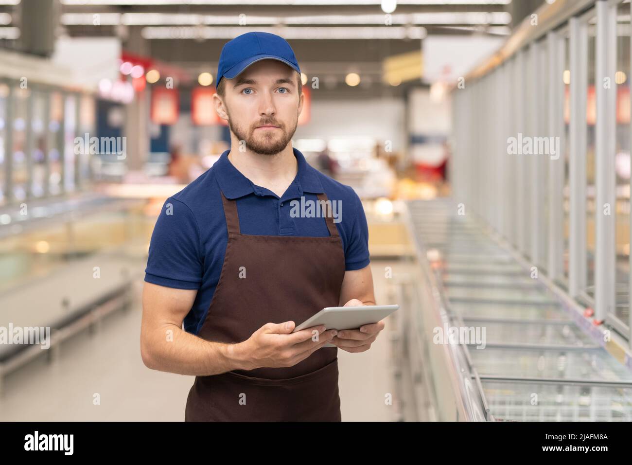 Horizontal medium portrait of modern young man wearing uniform working ...
