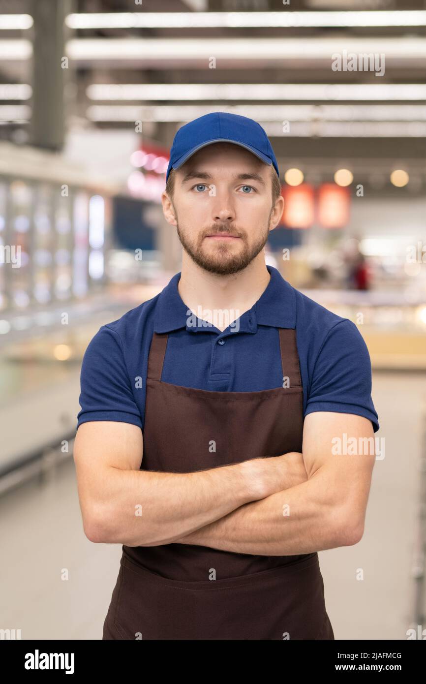 Horizontal medium portrait of modern young man wearing uniform working ...