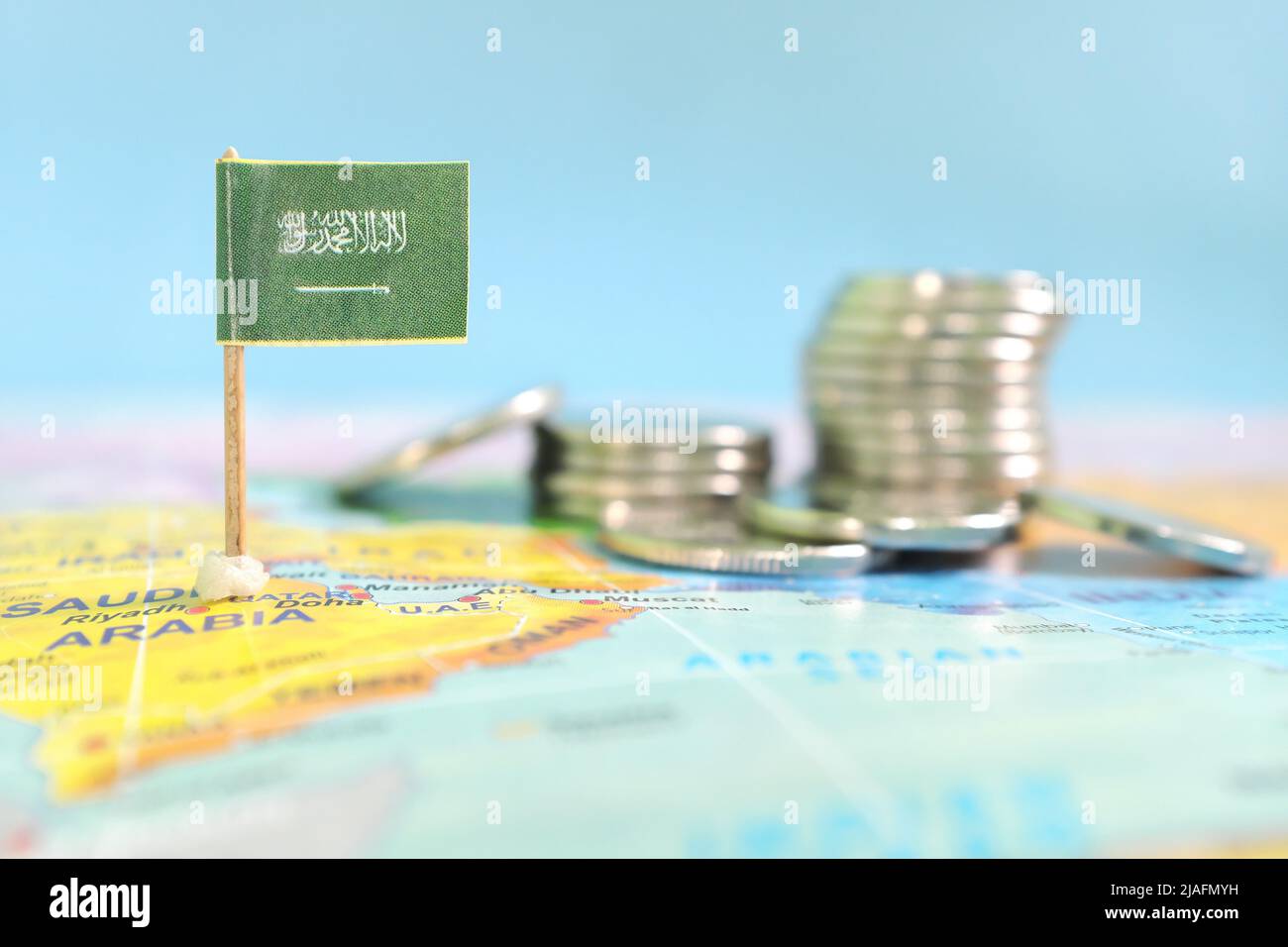Selective focus of Saudi Arabia flag in blurry world map with coins ...