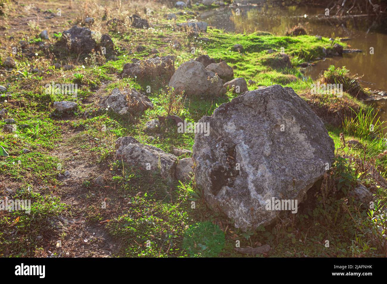 Big rocks at river bank . Idyllic riverside scenery Stock Photo - Alamy