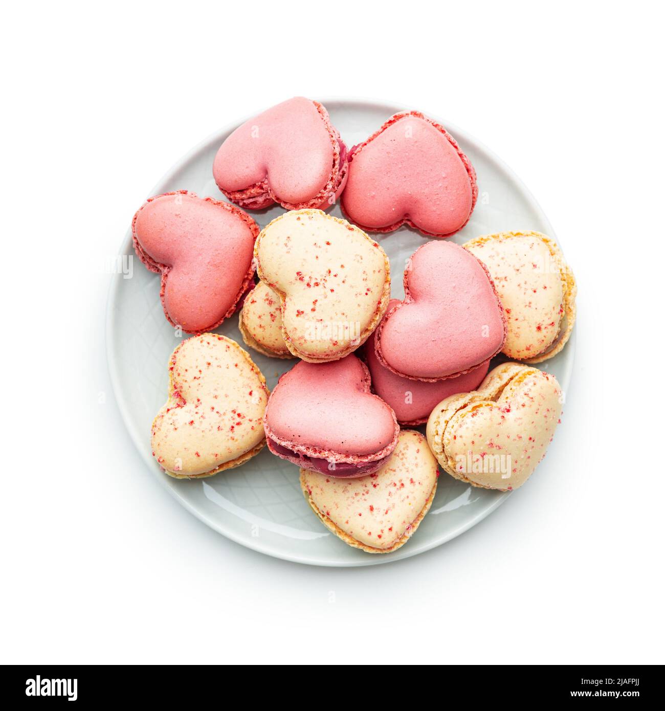 Heart shaped Sweet macarons on plate isolated on a white background ...